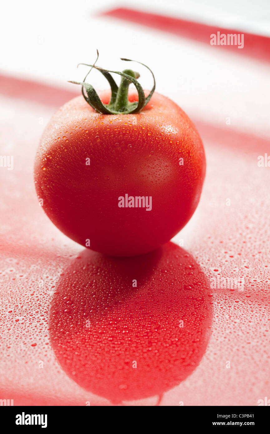 Ripe tomato with water droplets Stock Photo - Alamy