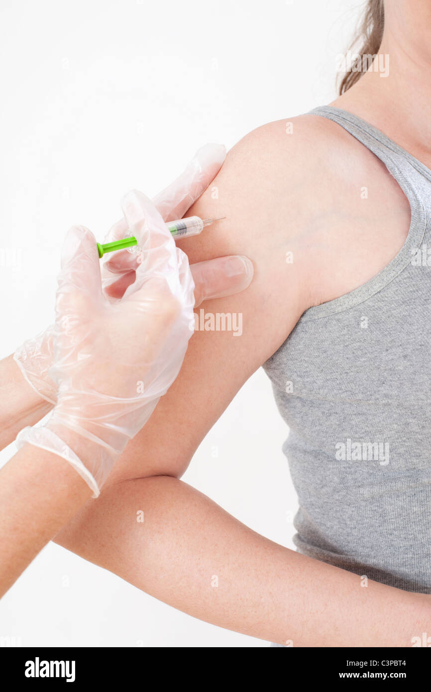 Woman getting an injection, close-up Stock Photo - Alamy