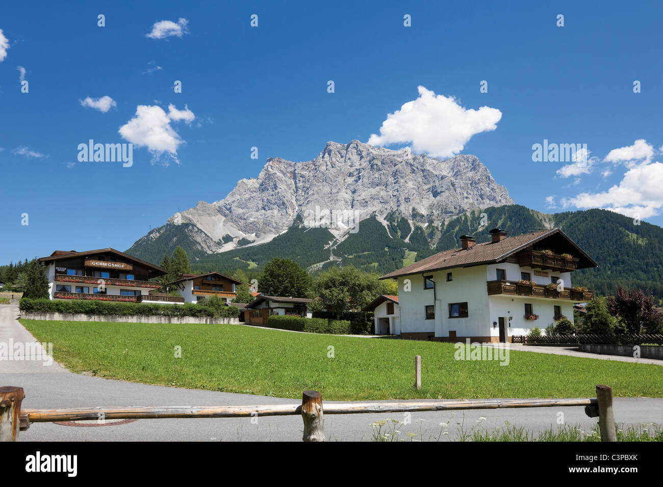 Austria, Tyrol, Ehrwald, View of houses with zugspitze mountain in ...
