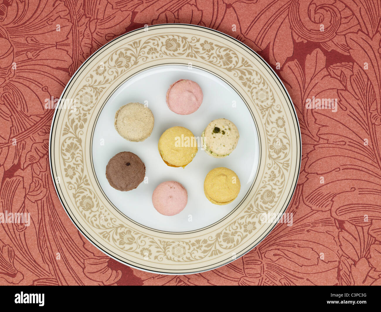 Petit fours in plate against patterned background Stock Photo - Alamy