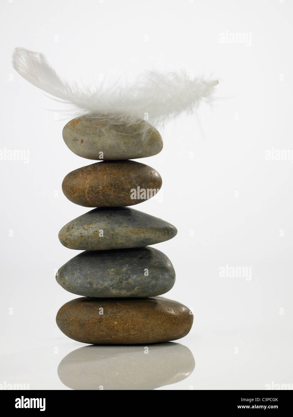 Stack of stones with feather on white background, close up Stock Photo ...