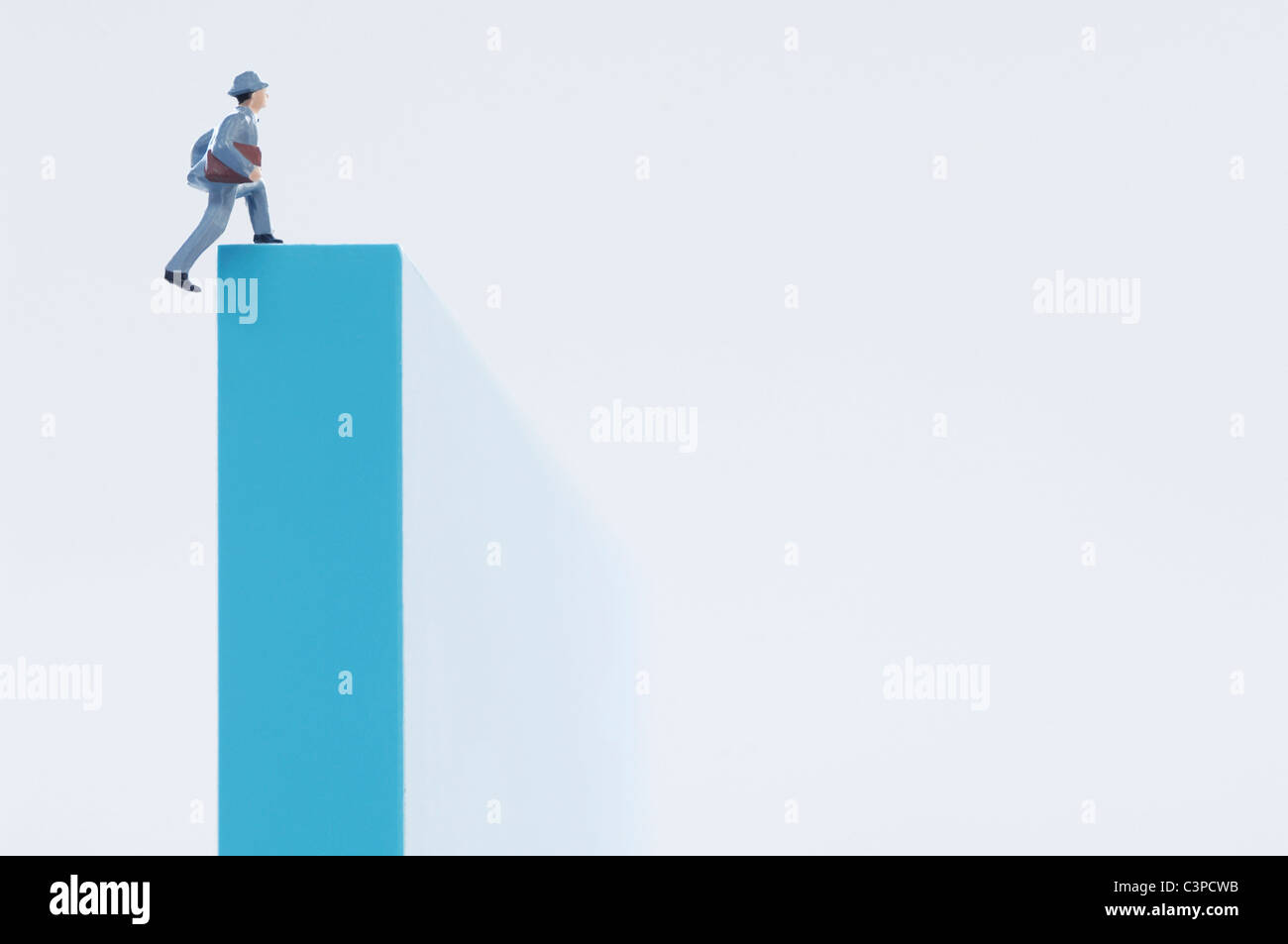 Businesspeople figurine walking on a block Stock Photo - Alamy