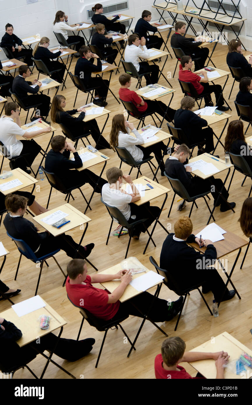 Comprehensive secondary school students sitting at desks taking their ...