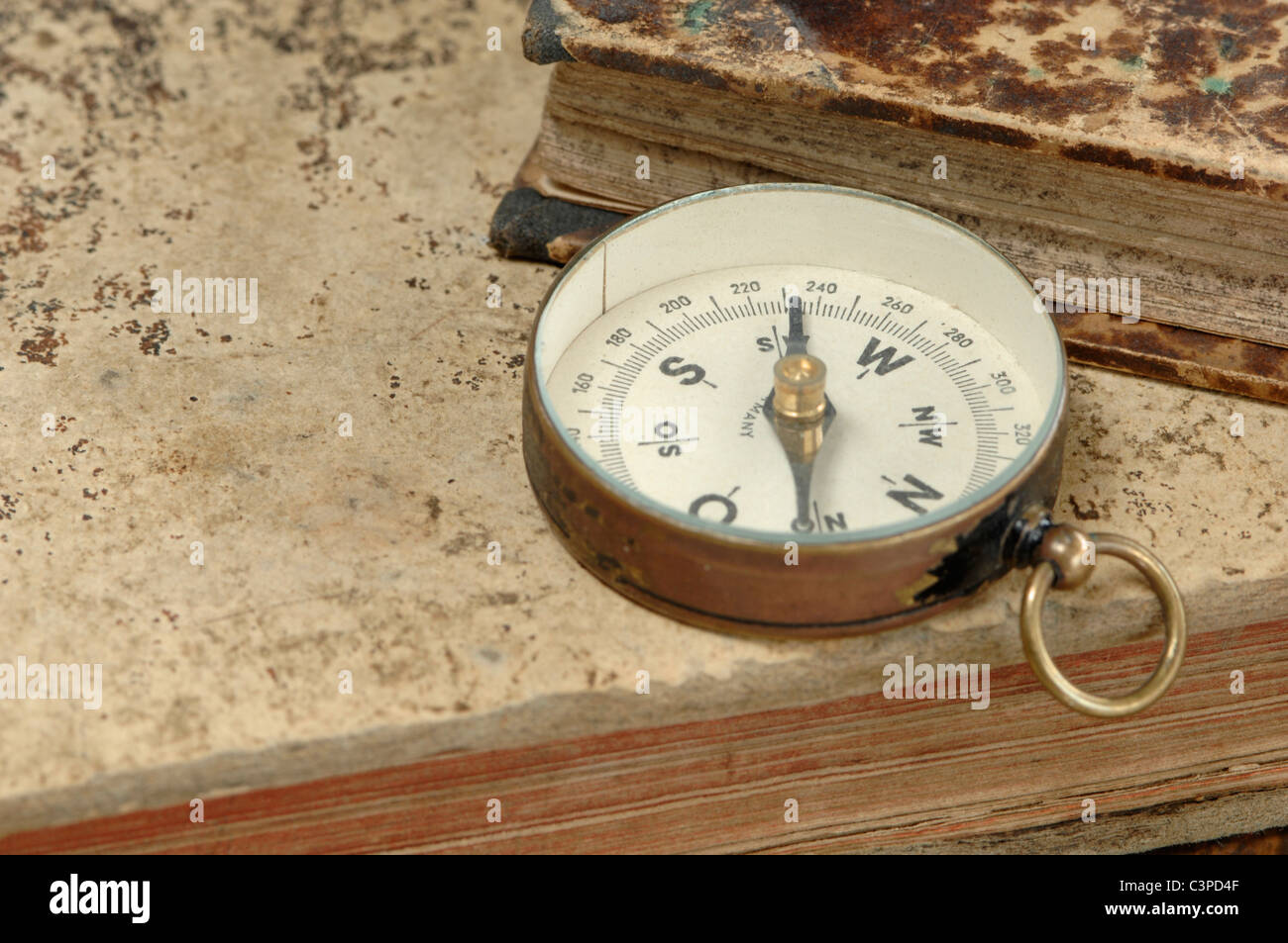 Compass with old book hi-res stock photography and images - Alamy