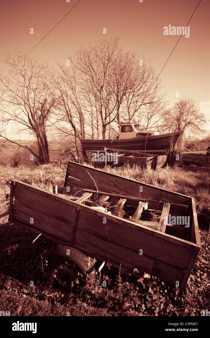Split toned image of an old trailer and boats Stock Photo - Alamy