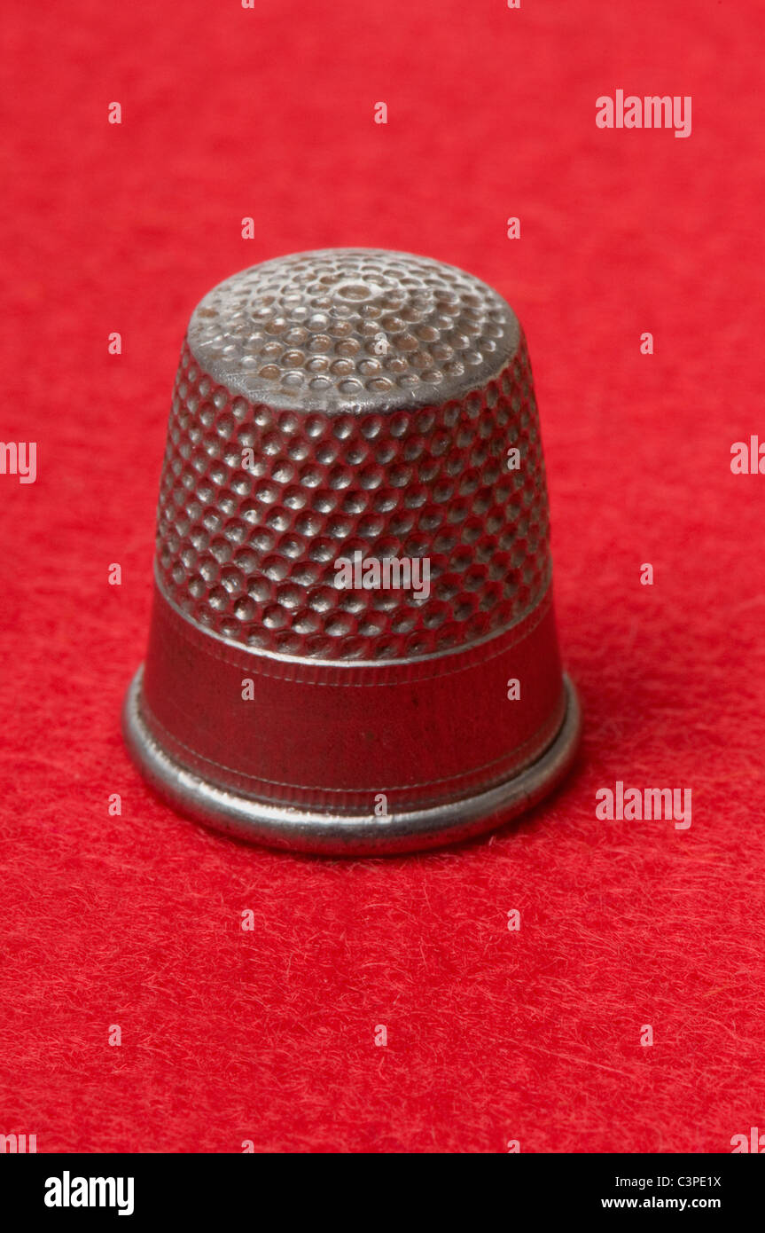 Thimbles on red background Stock Photo - Alamy