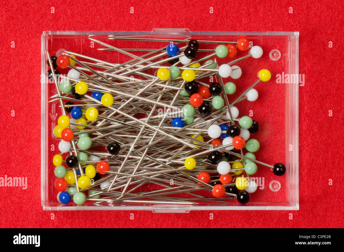 Fixing pins in box on red background Stock Photo - Alamy