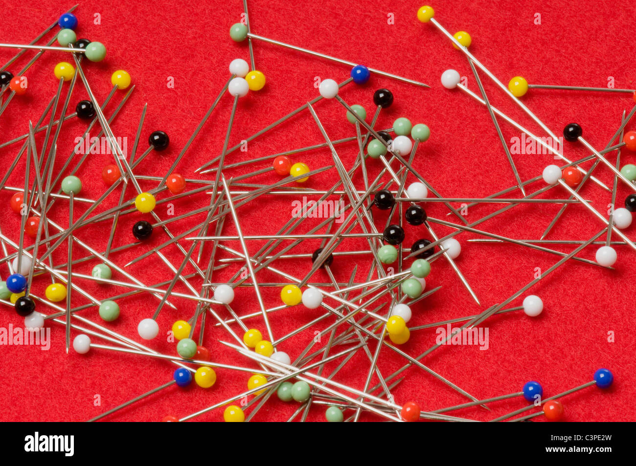 Fixing pins on red background Stock Photo - Alamy
