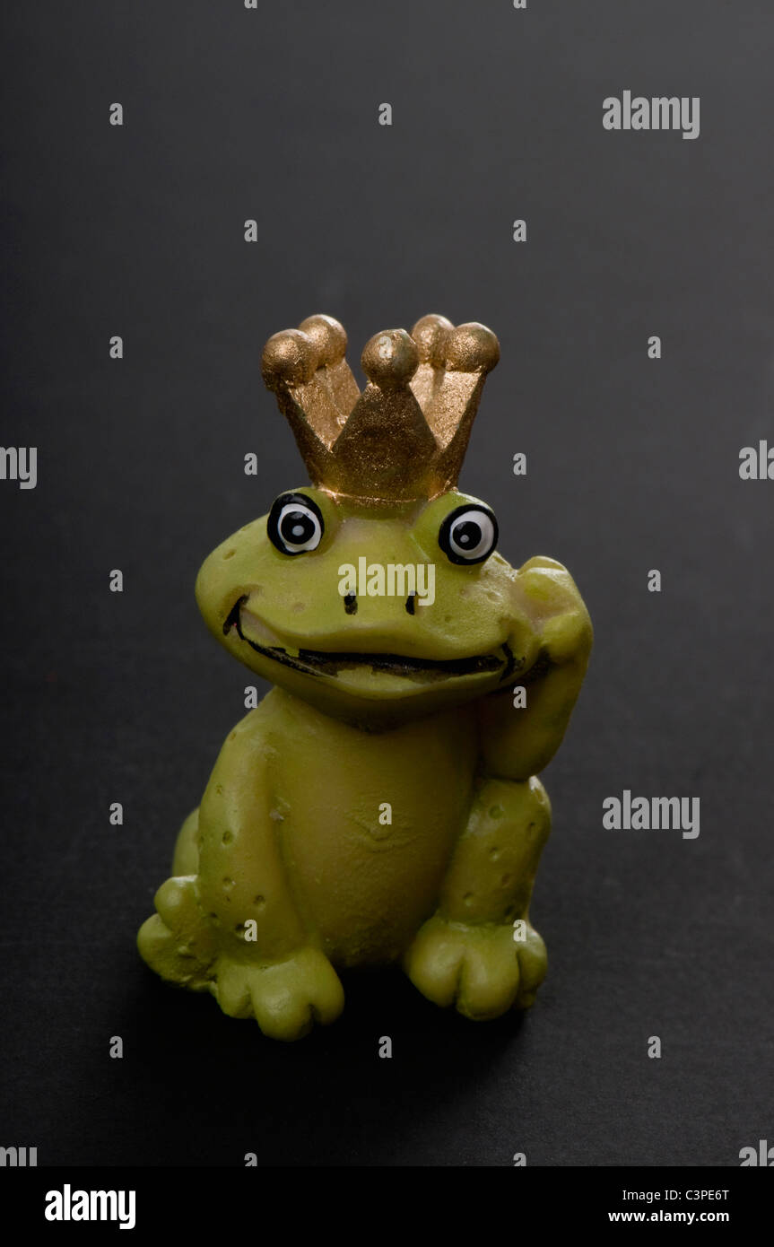 Miniature frog with crown on black background Stock Photo - Alamy