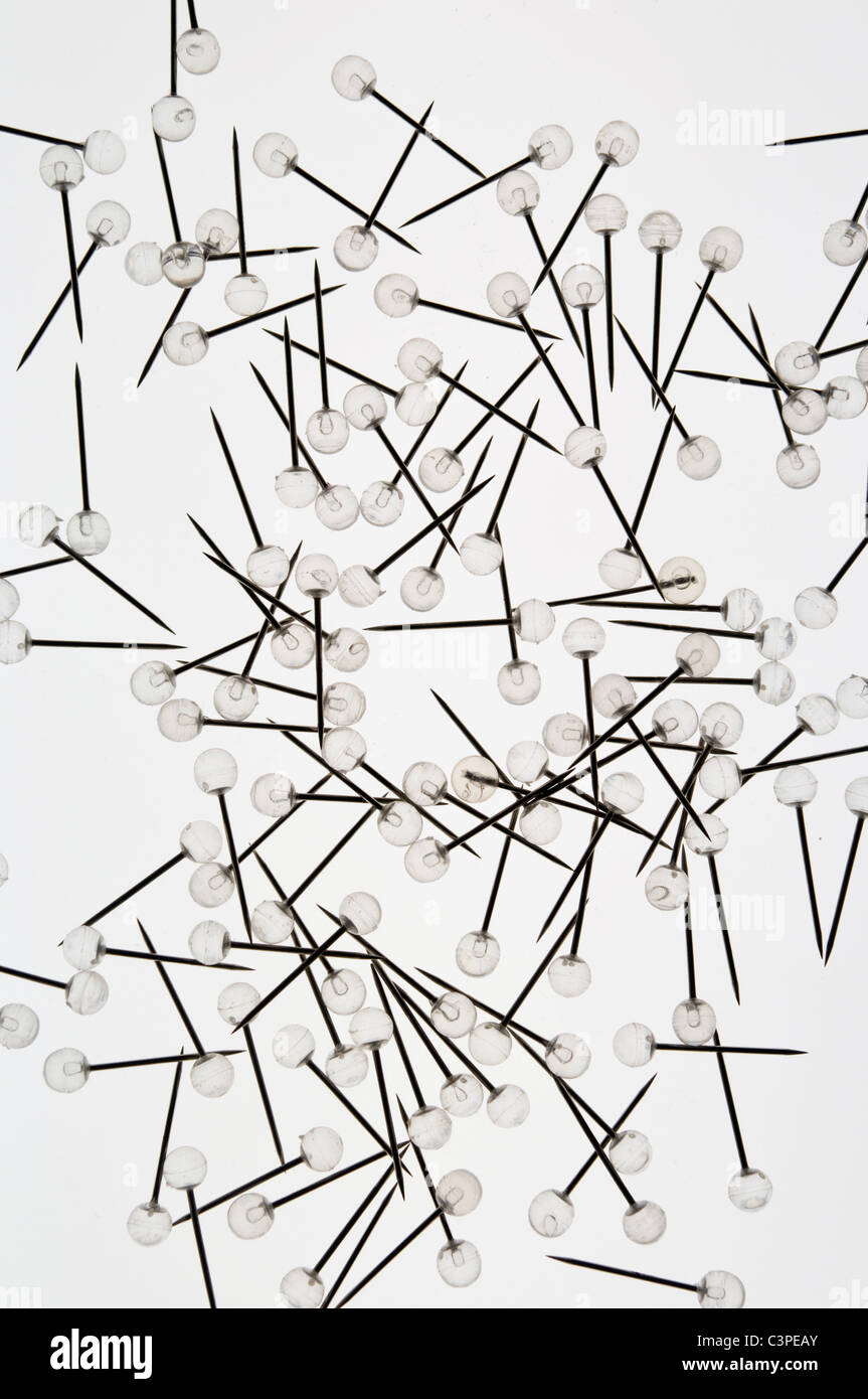 Fixing pins on white background Stock Photo - Alamy