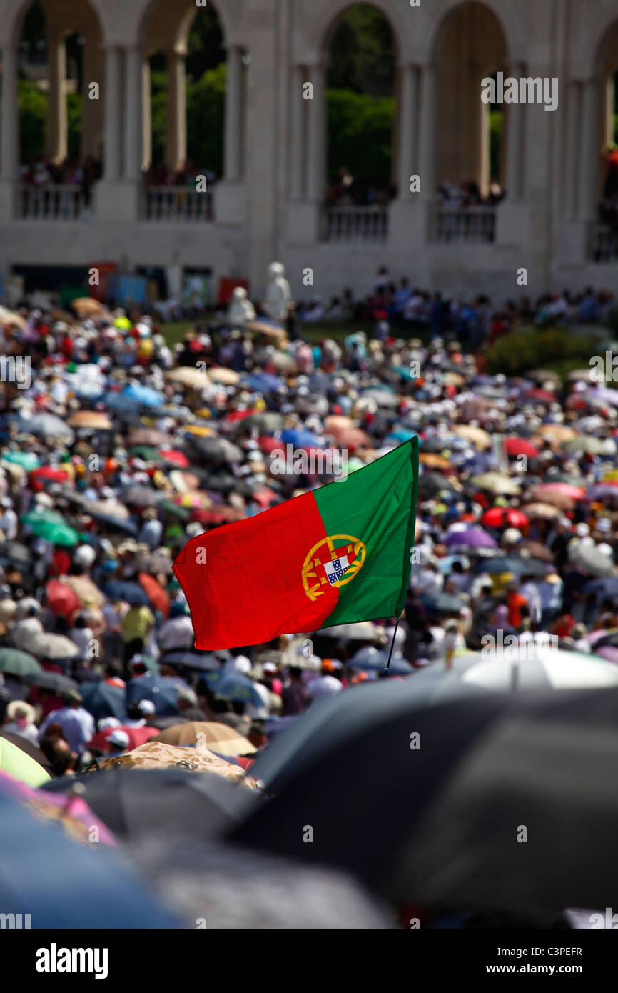A Portuguese flag flies over Roman Catholics celebrating the Feast of ...