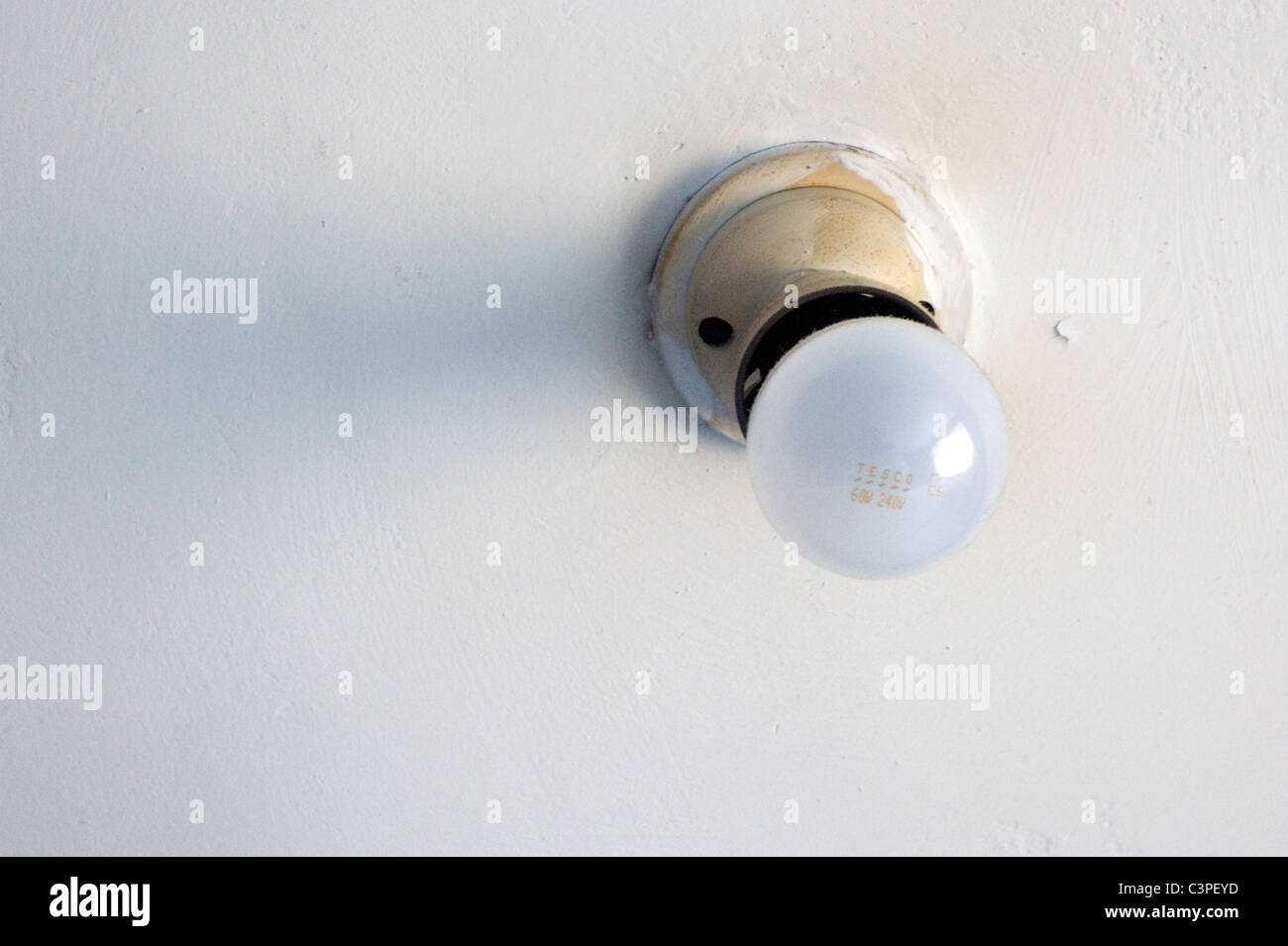 traditional old style incandescent light bulb in ceiling socket Stock ...