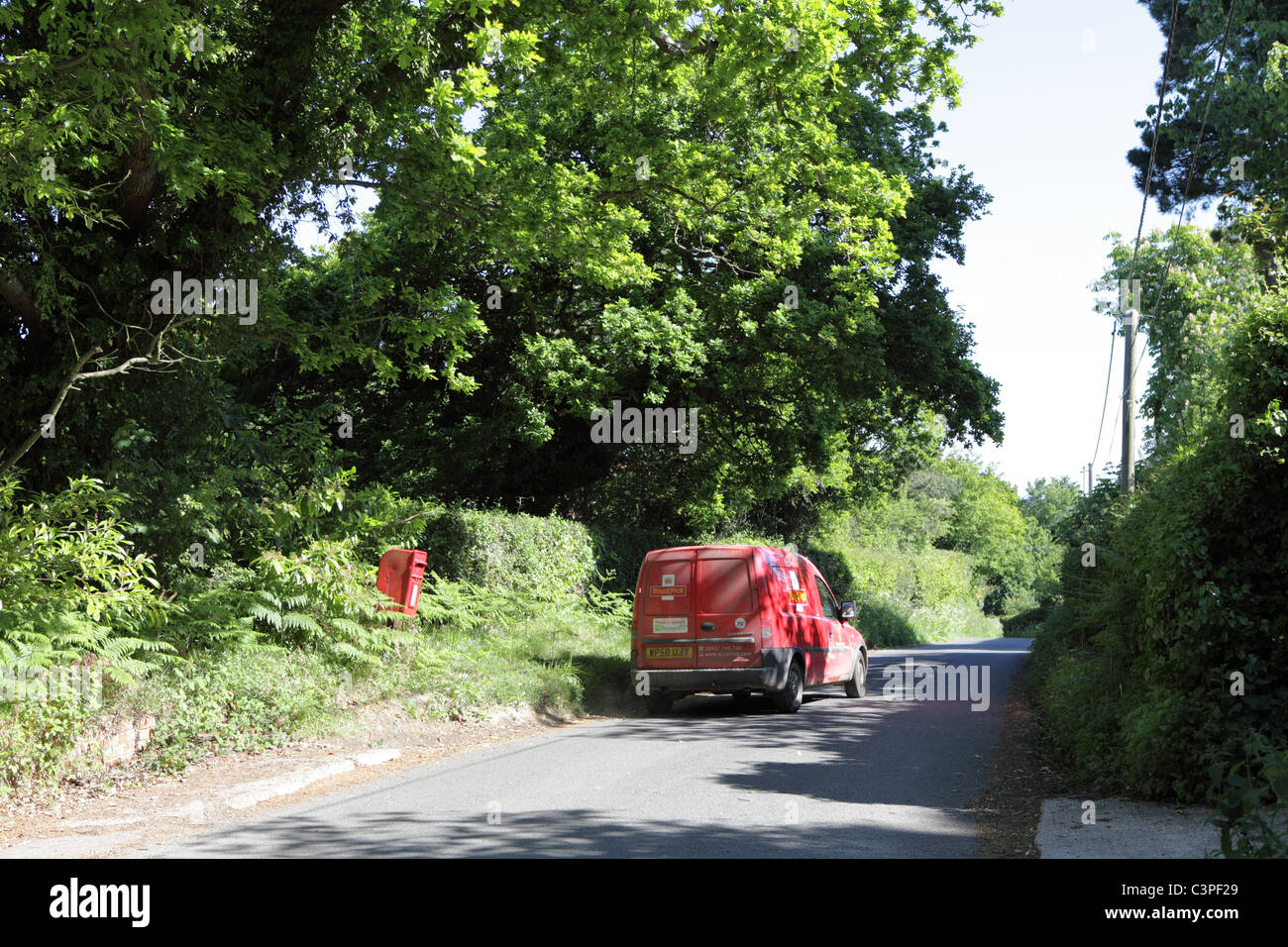 Royal Mail van collecting from rural postbox, East Sussex, England ...