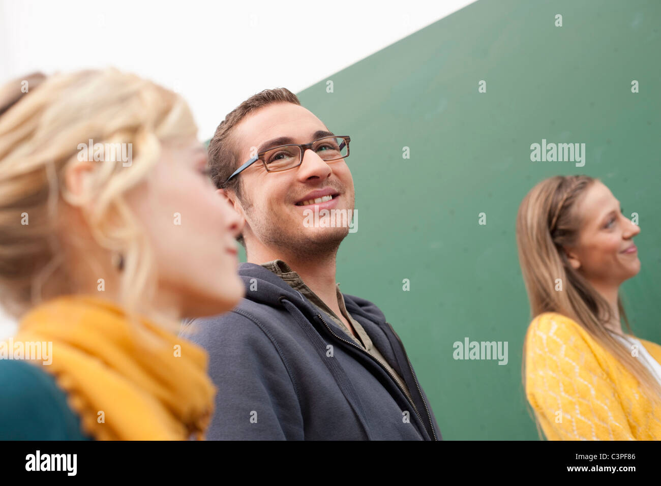 Germany, Leipzig, University students sitting together, smiling Stock ...