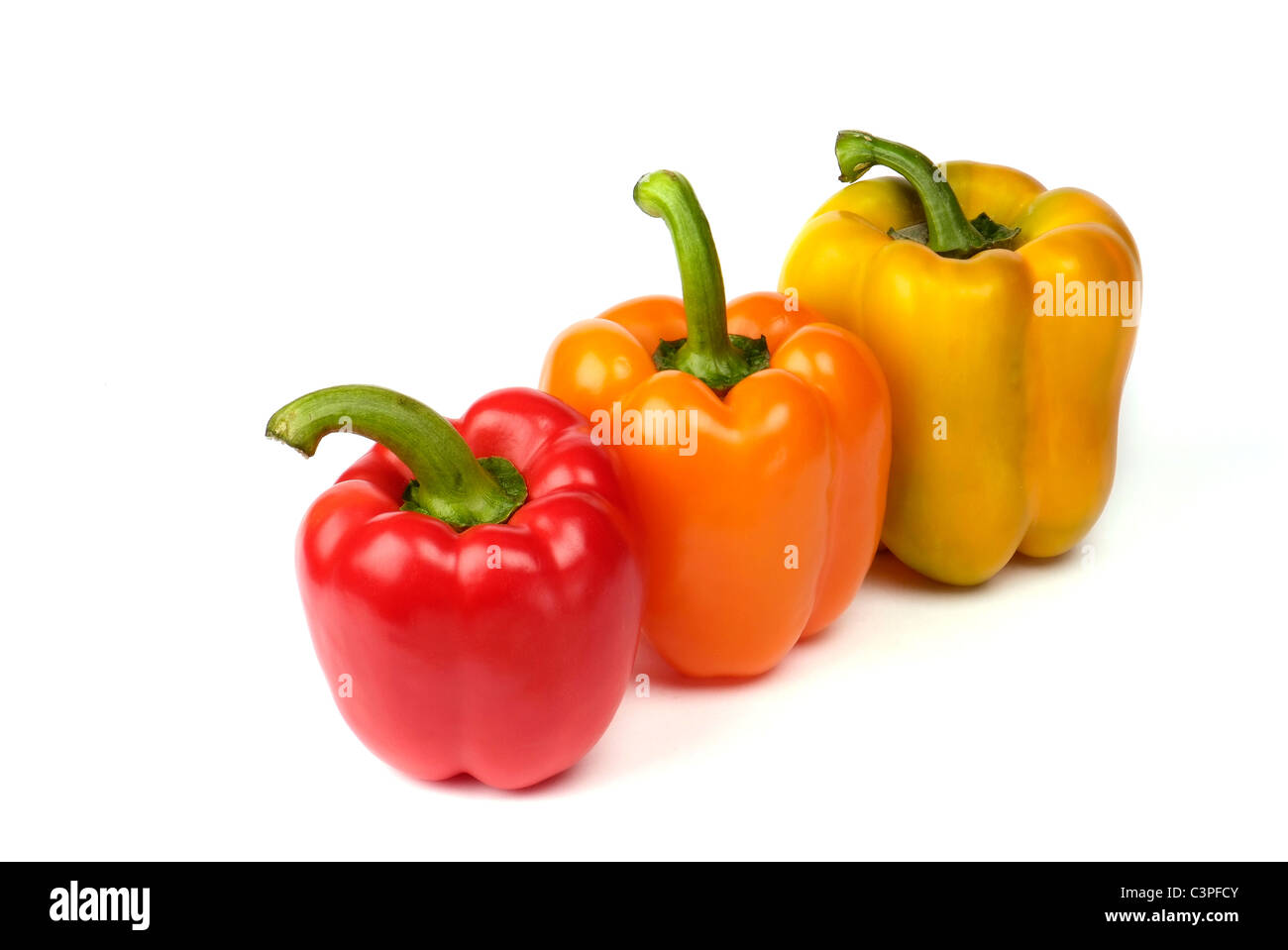 three peppers in a row isolated on white Stock Photo - Alamy