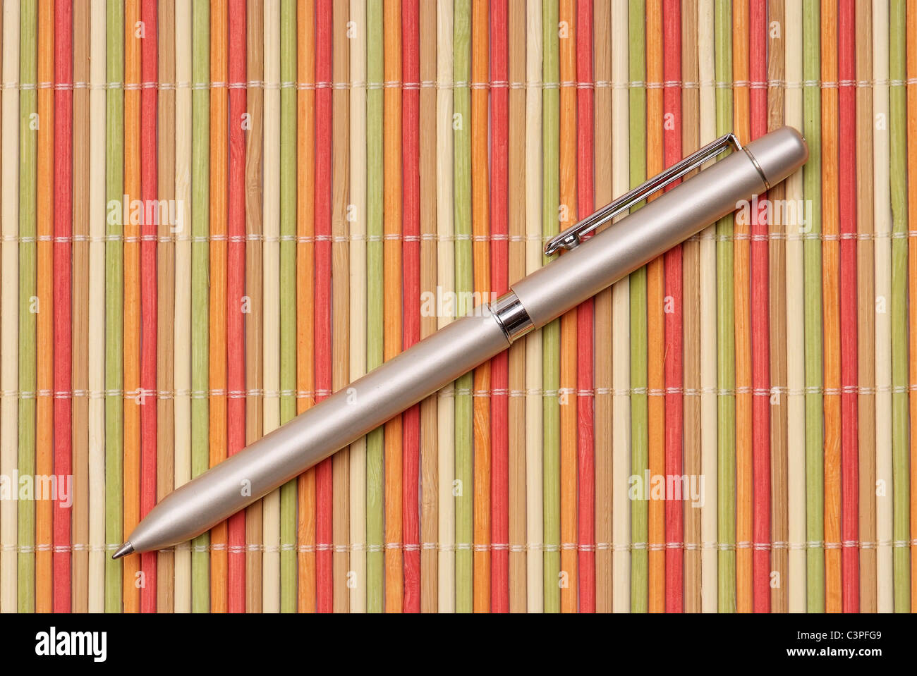 pen on colorful bamboo mate Stock Photo - Alamy