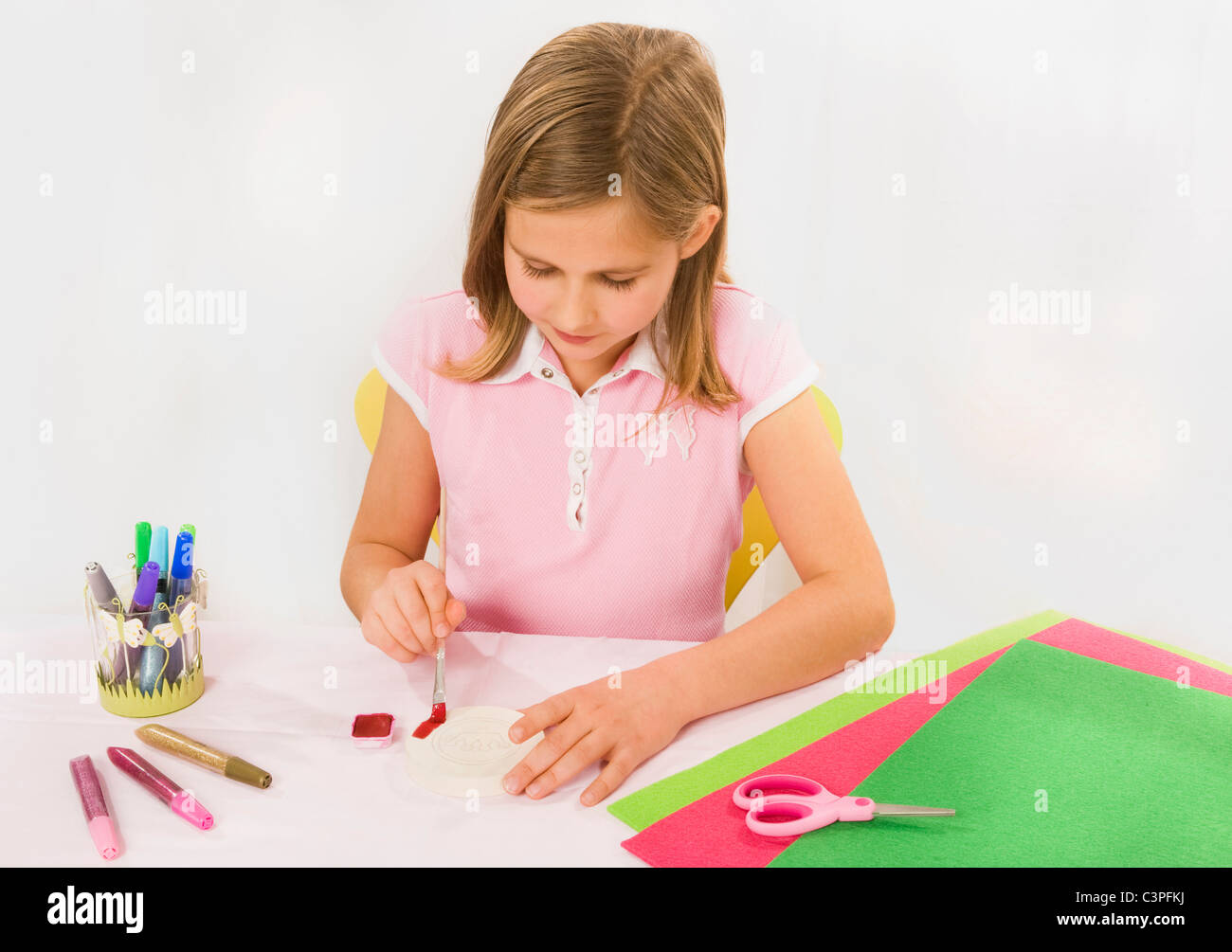 Girl (8-9) tinkering, portrait Stock Photo - Alamy