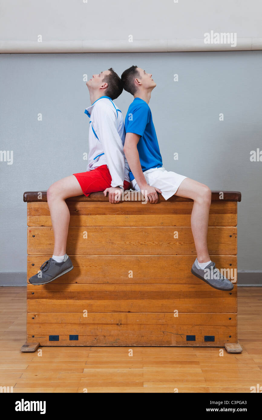 Germany, Berlin, Young men sitting on vaulting horse Stock Photo - Alamy