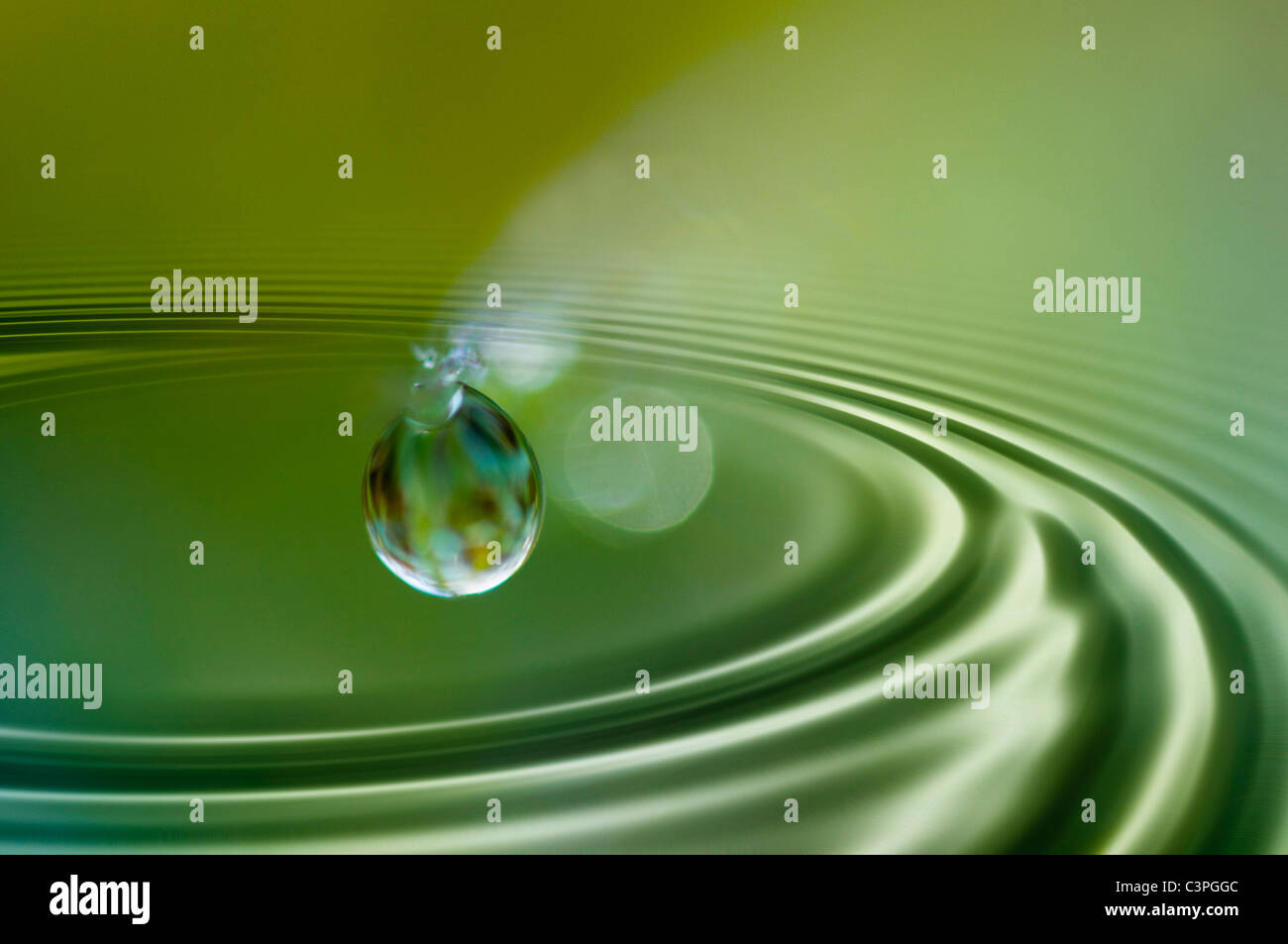 Germany, Water droplet reflecting in water, close-up Stock Photo - Alamy