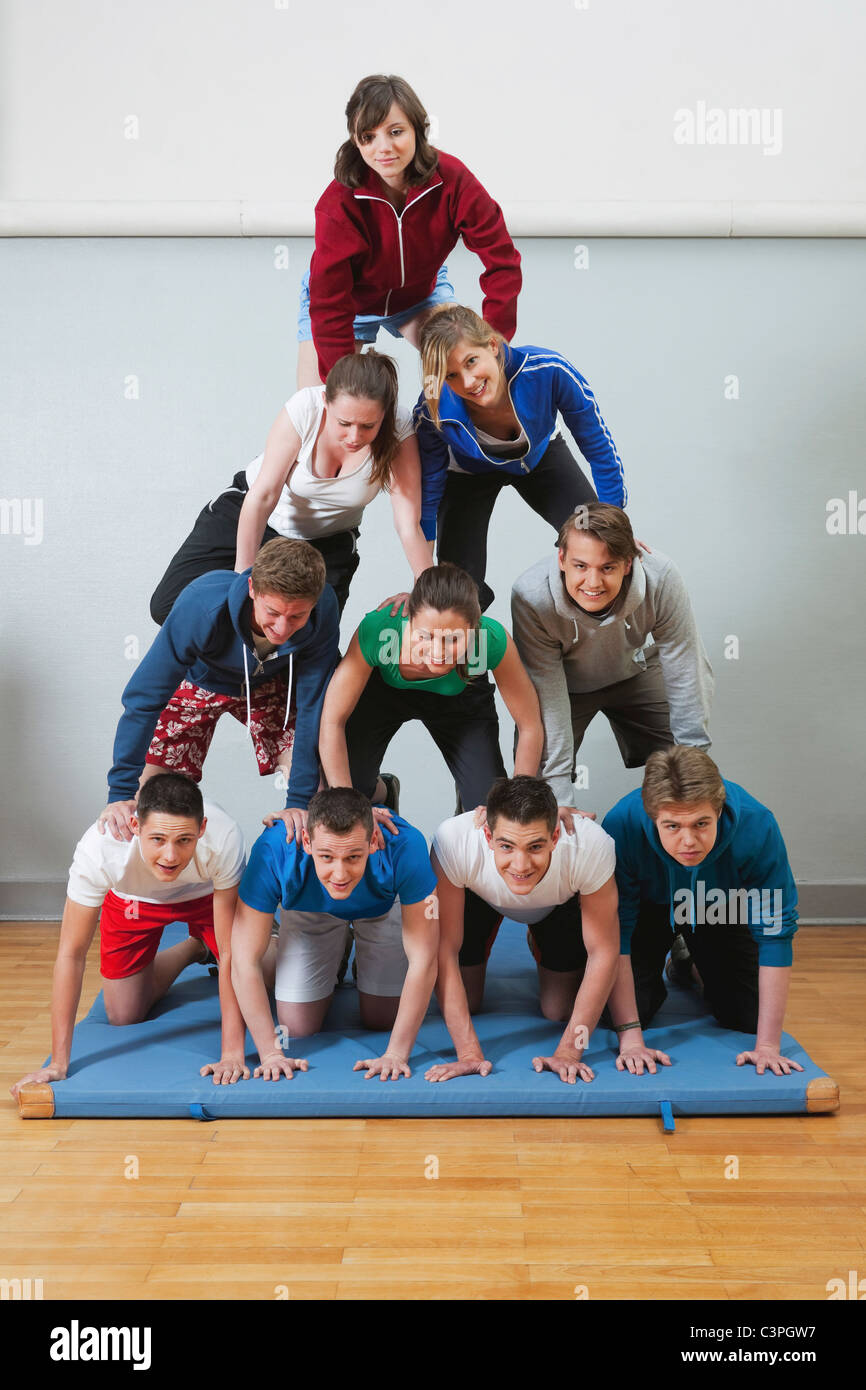Germany, Berlin, Young people and teenager building human pyramid Stock ...