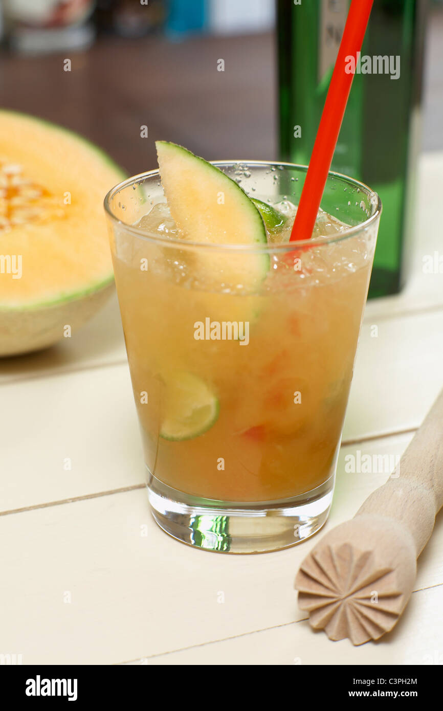 Cocktail with slice of melon and lime, close up Stock Photo - Alamy