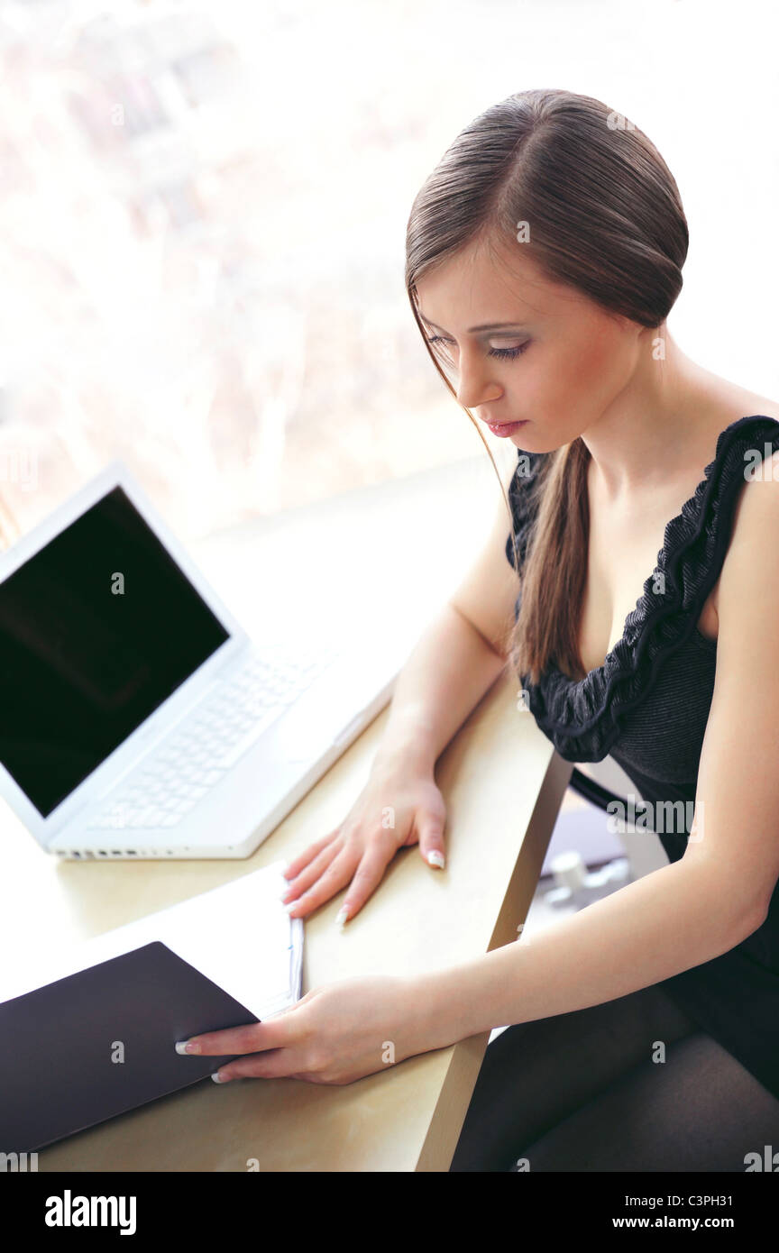 Closeup Portrait of business woman working with folder of documents and ...
