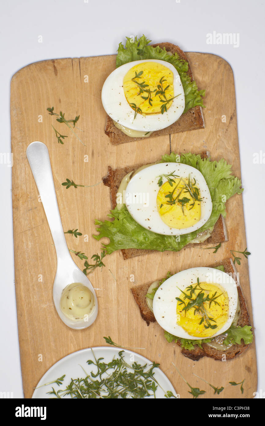 Boiled egg on rye bread garnished with cress Stock Photo - Alamy