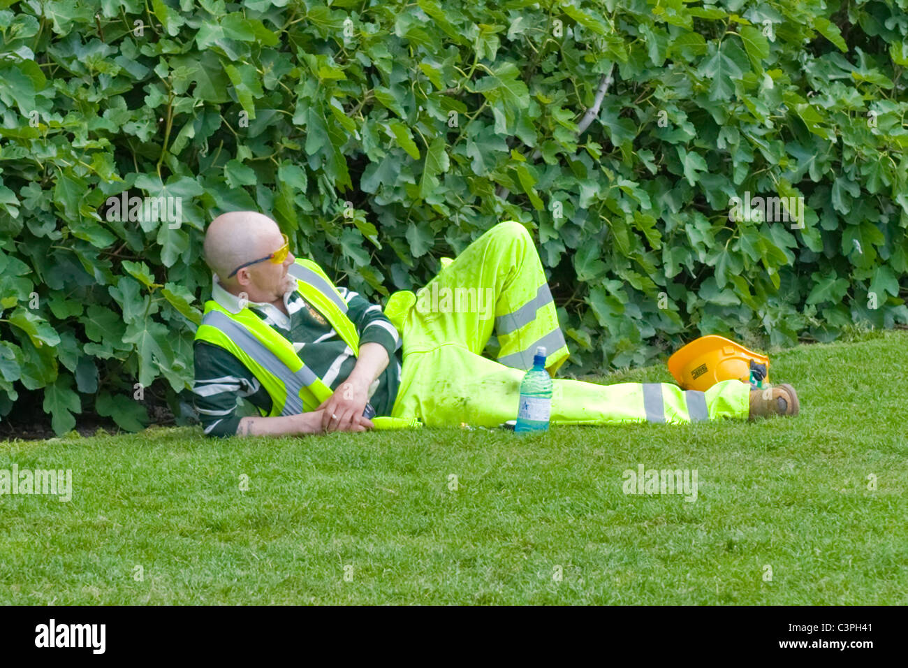 London , Westminster , National Gallery , British Worker lying on lawn ...