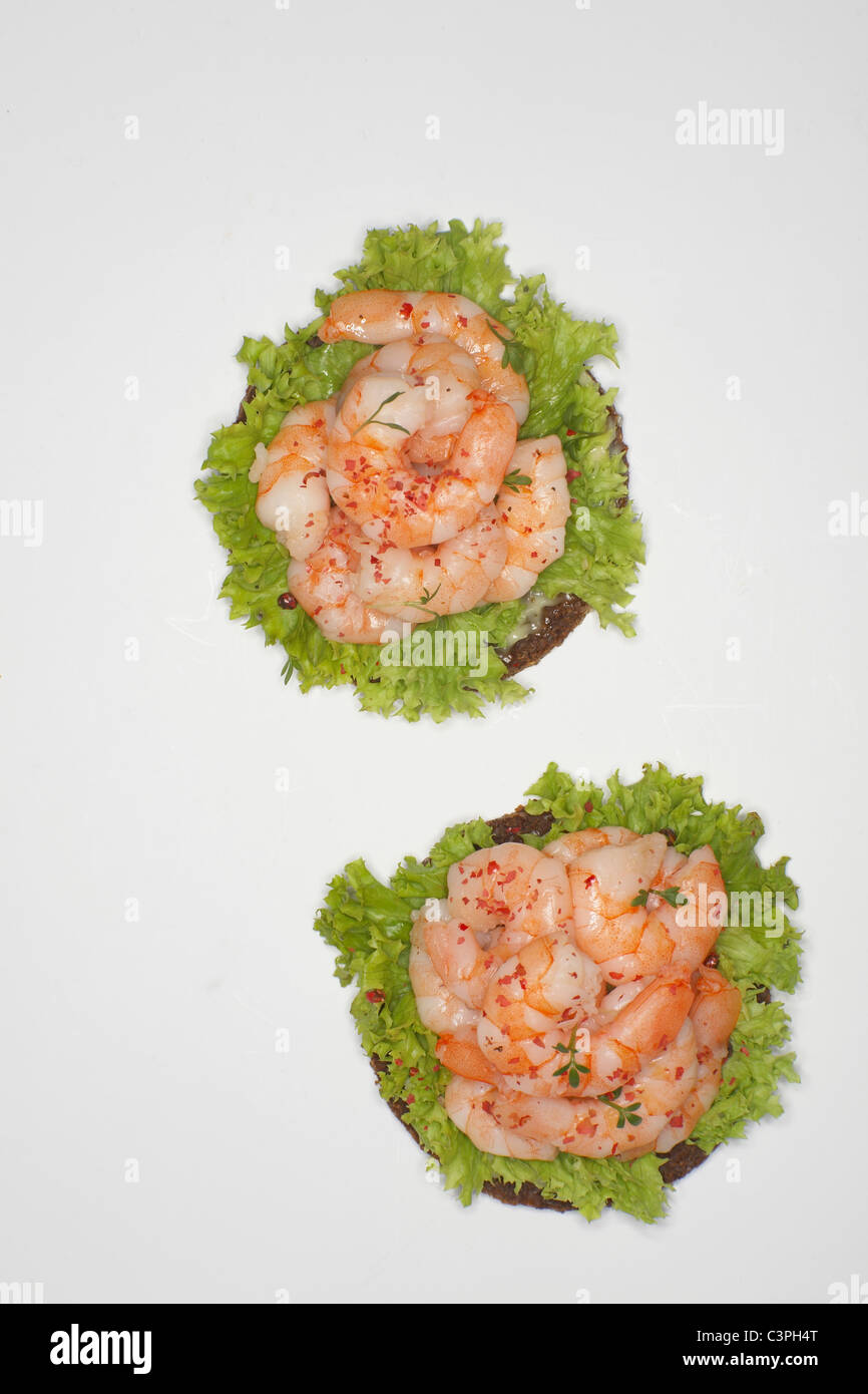 Prawns on pumpernickel with salad against white background Stock Photo ...