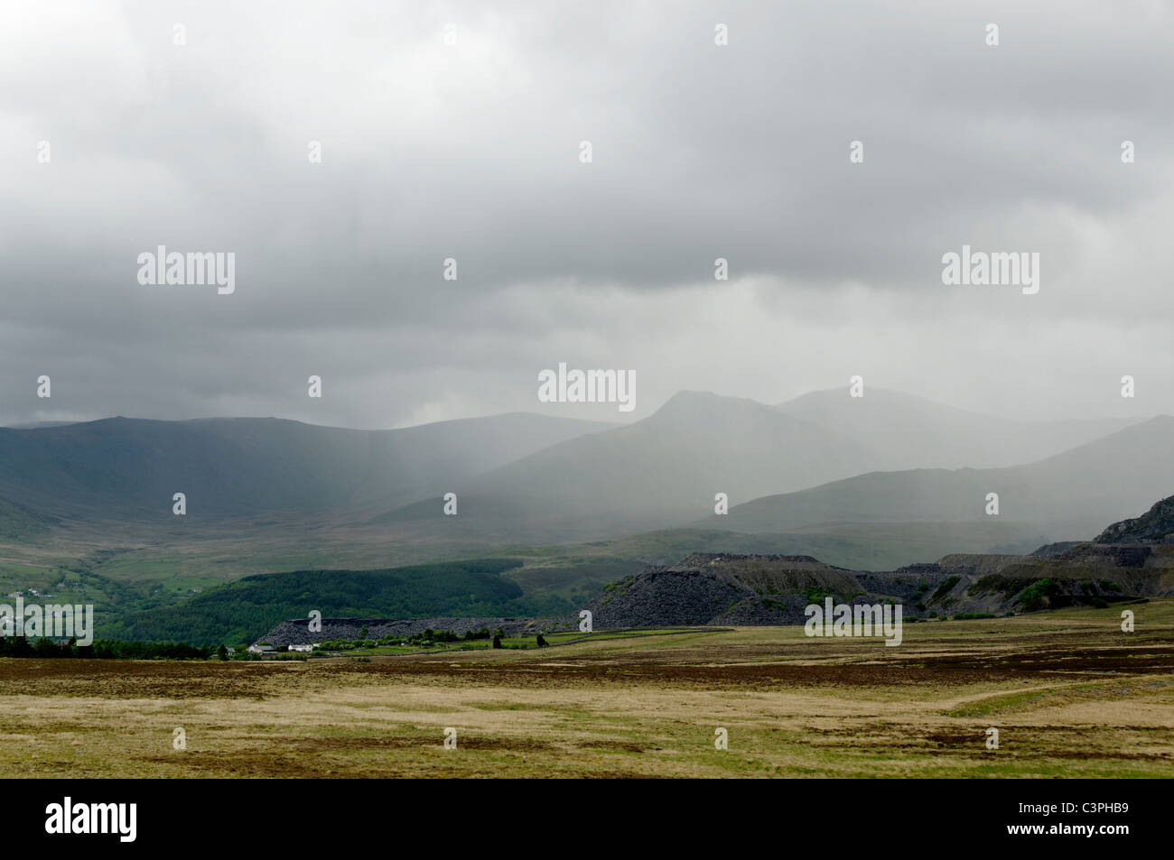 A large rain cloud crossing the Carneddau mountains in Snowdonia Stock ...