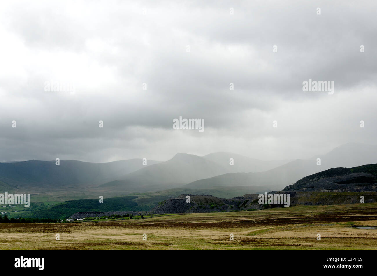 A large rain cloud crossing the Carneddau mountains in Snowdonia Stock ...