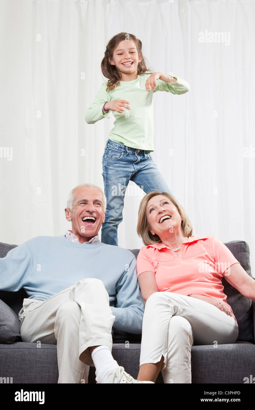 Granddaughter (6-7) dancing and grandparents enjoying, smiling Stock ...