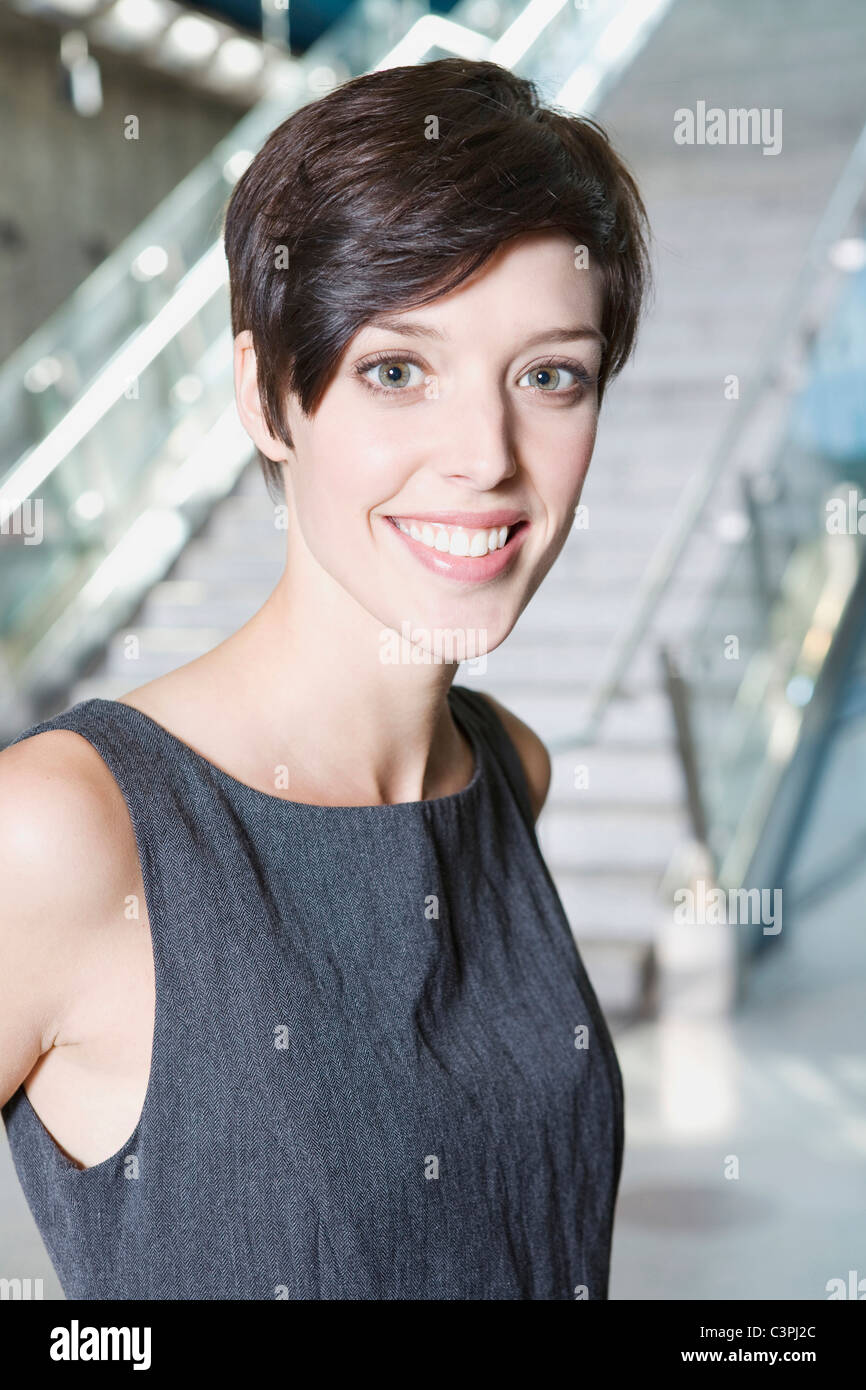 Germany, Bavaria, Munich, Business woman at subway station, smiling ...
