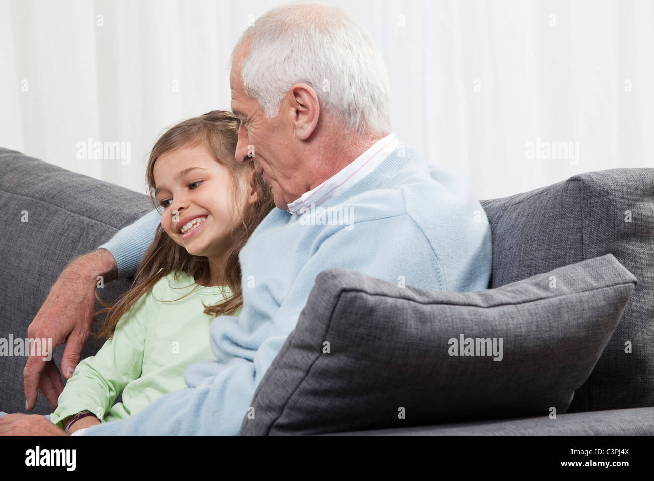 Granddaughter whispering to grandfather hi-res stock photography and ...