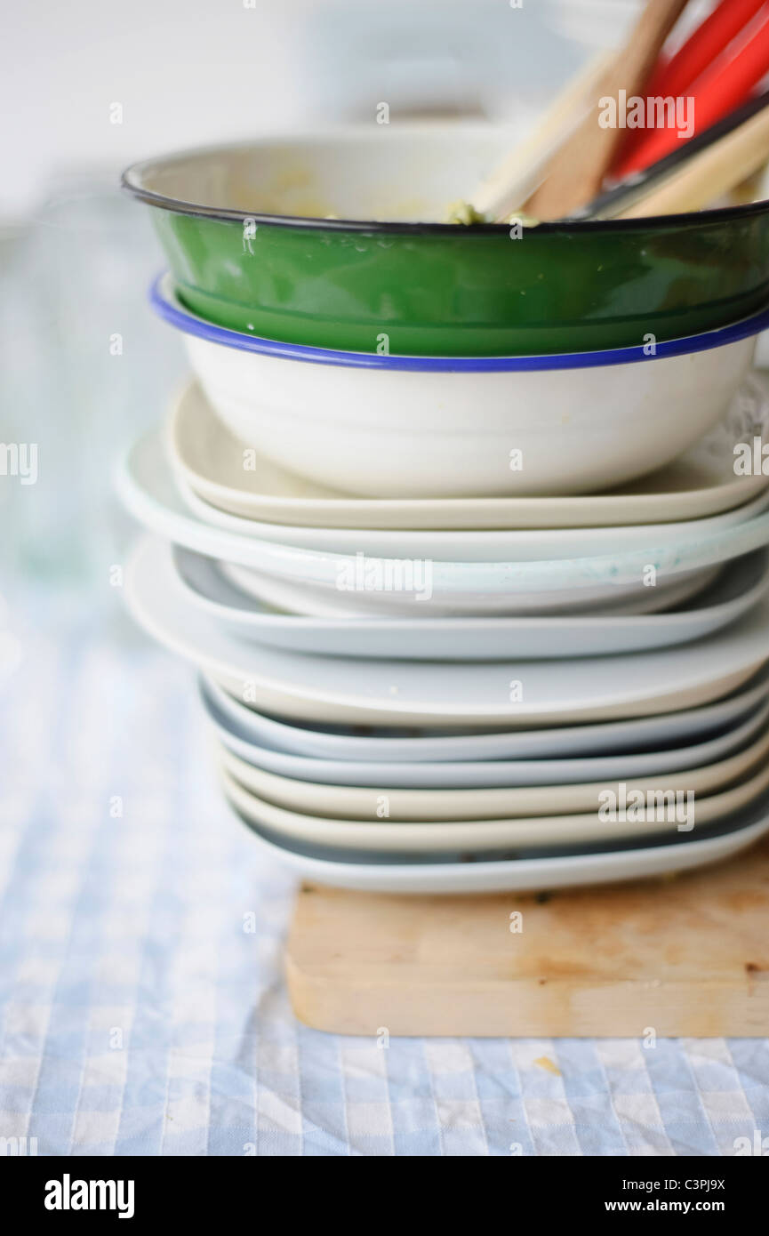 Stack of dirty dishes on table cloth Stock Photo - Alamy