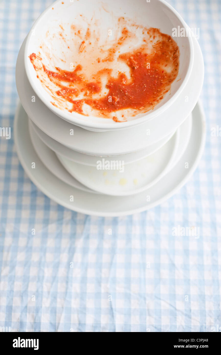 Stack of dirty dishes on table cloth Stock Photo - Alamy