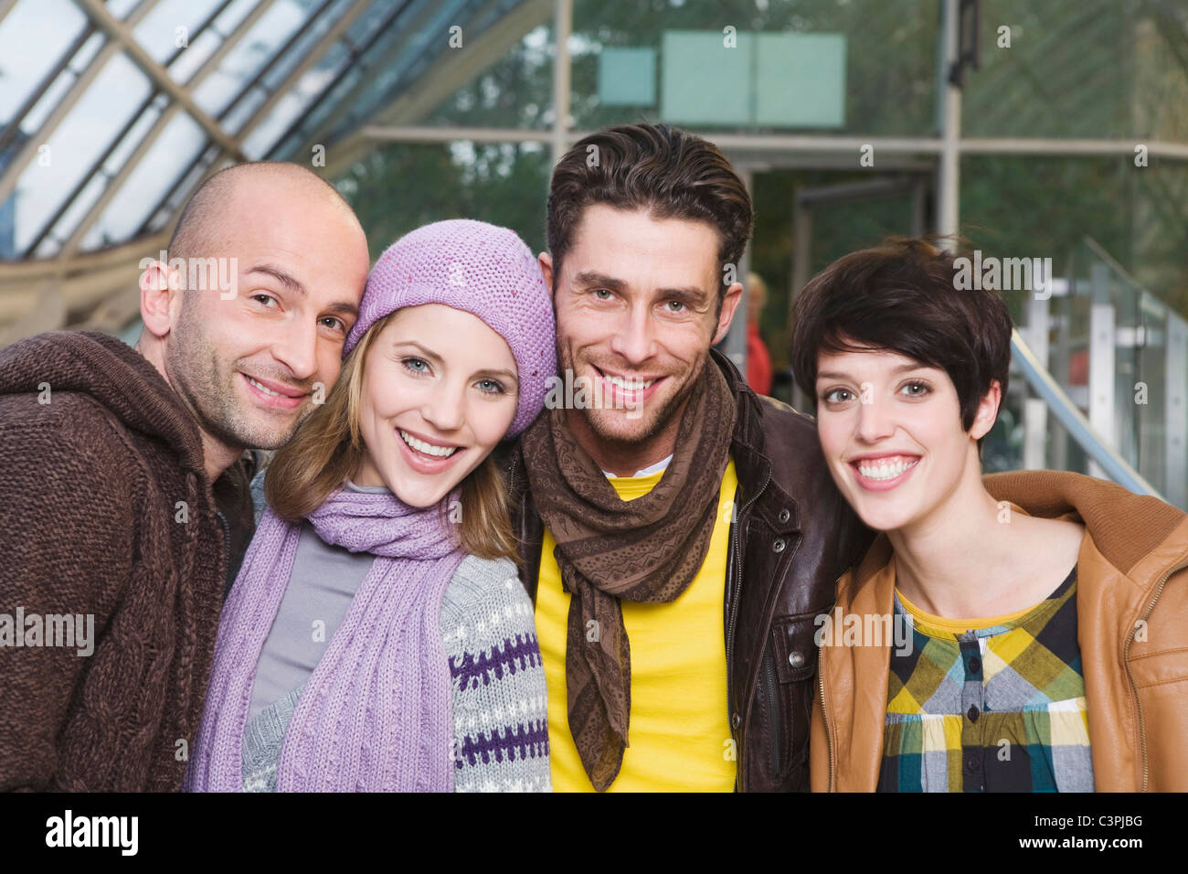 Germany, Bavaria, Munich, Four people, smiling, portrait, close-up ...