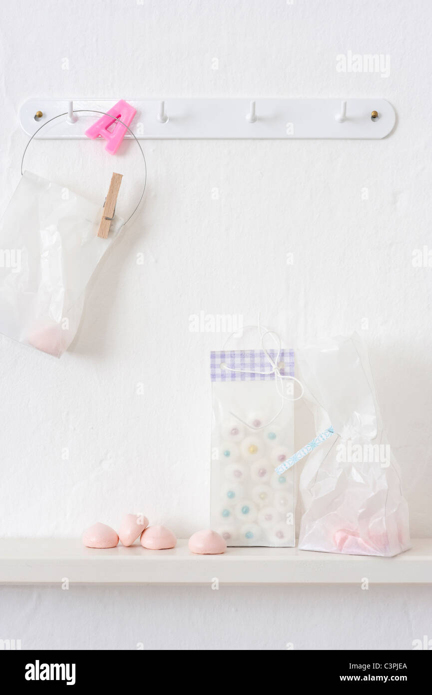 Pastries in plastic bags hanging on hook rack Stock Photo - Alamy