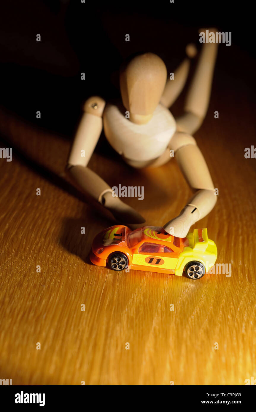 A mannequin with a toy car Stock Photo - Alamy