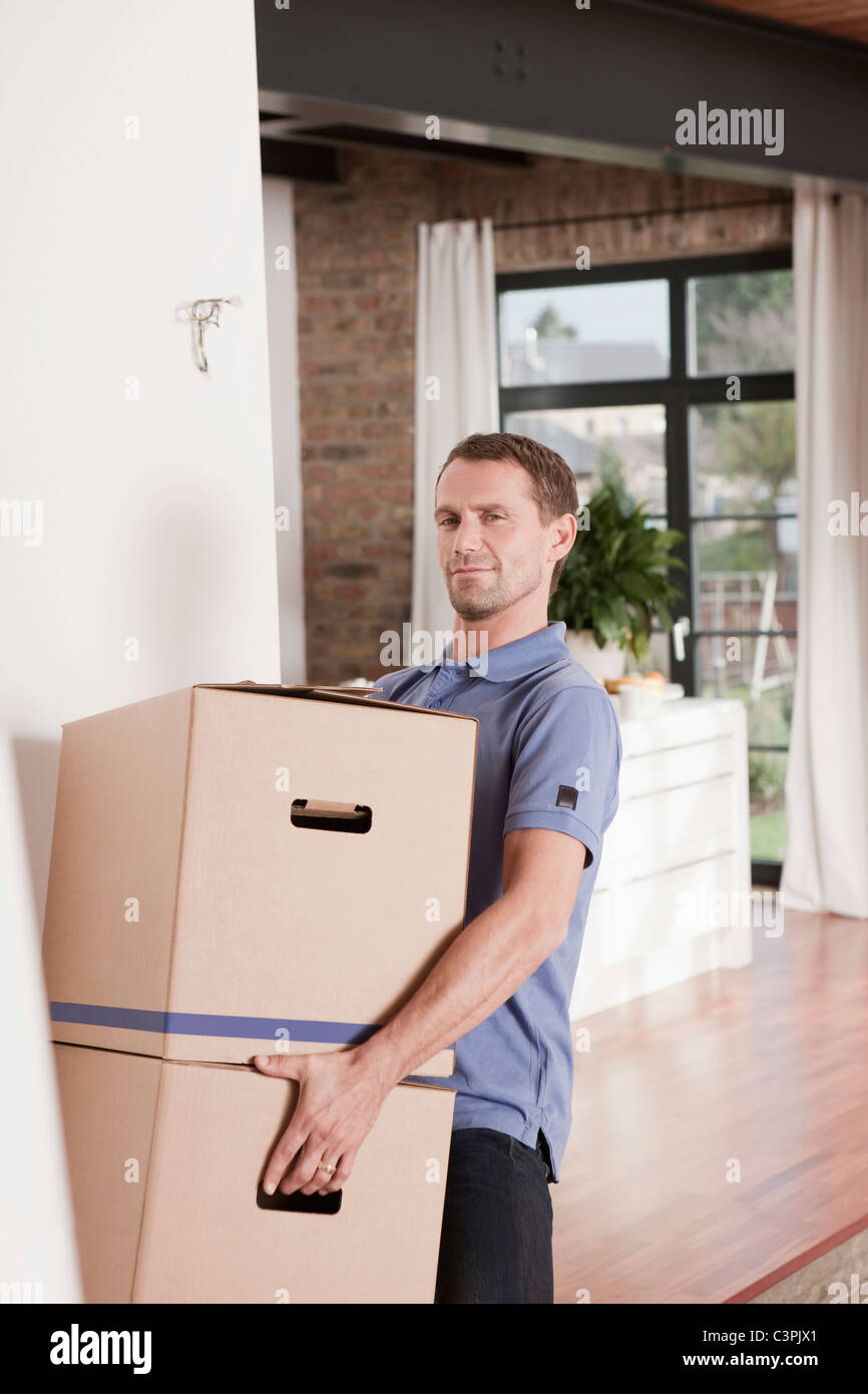 Germany, Cologne, Man carrying packing cases Stock Photo - Alamy