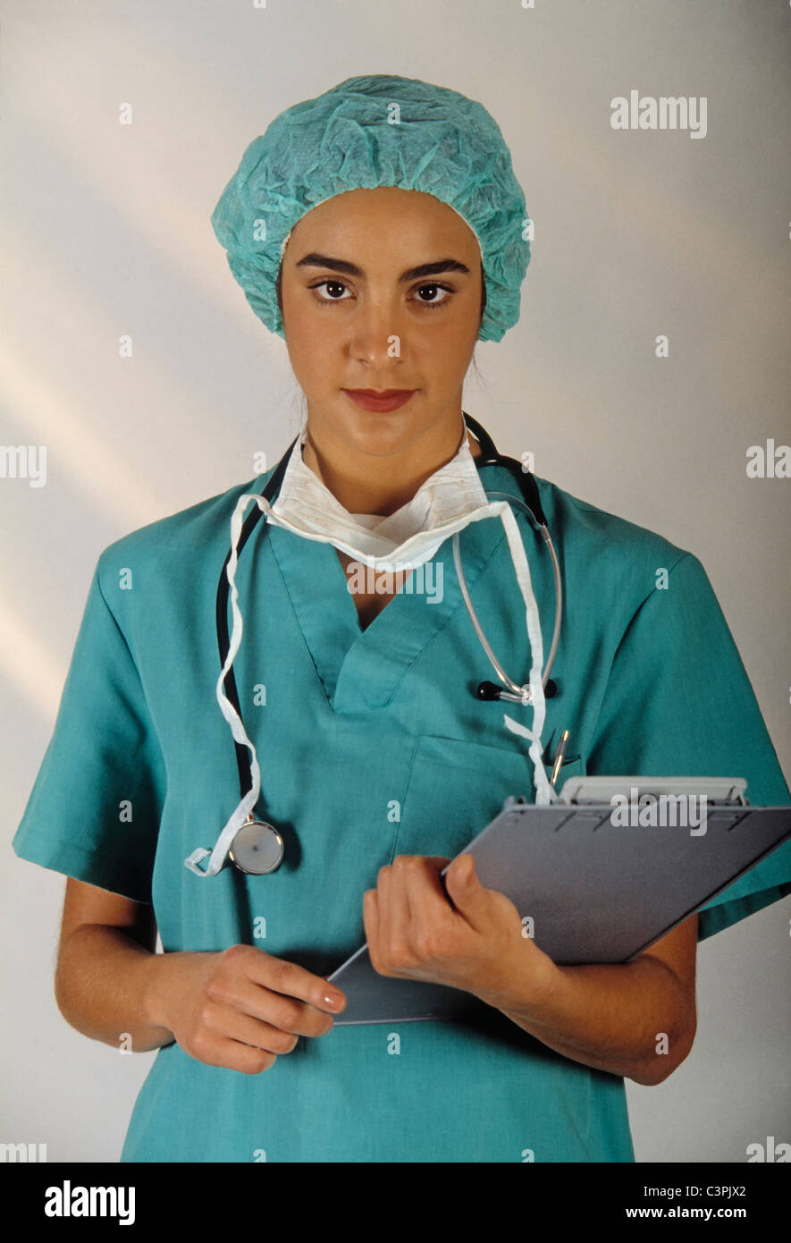 Medical doctor looking straight at camera and holding a clipboard Stock ...