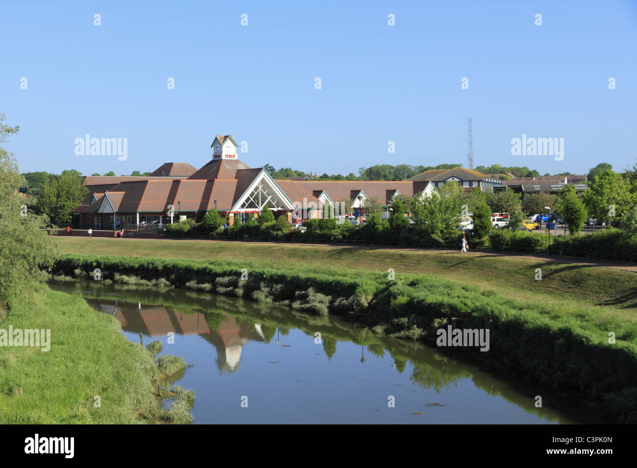 A Tesco Superstore reflected in the River Ouse, Lewes, East Sussex ...