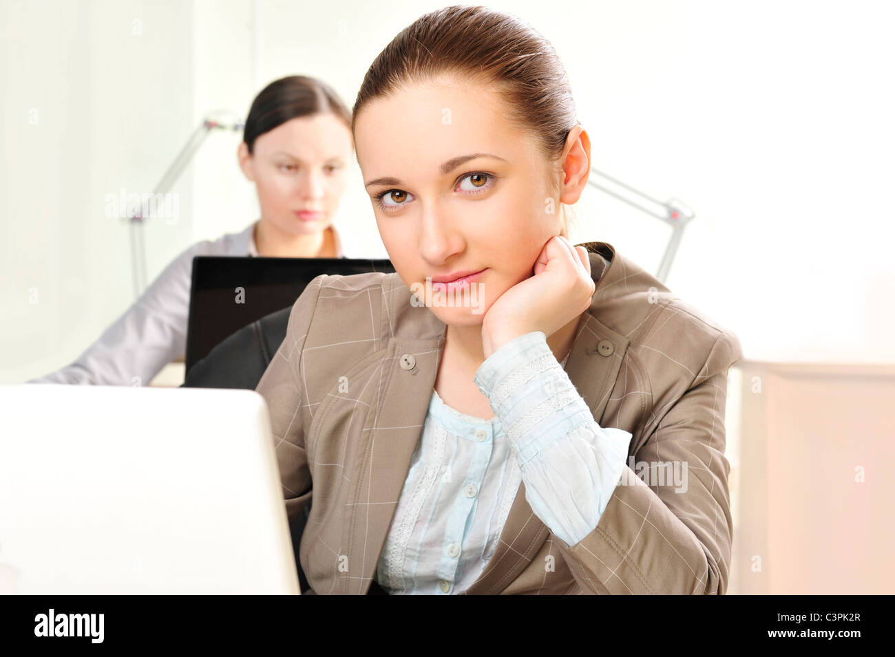 Portrait of relaxed and happy business woman in an office environment ...