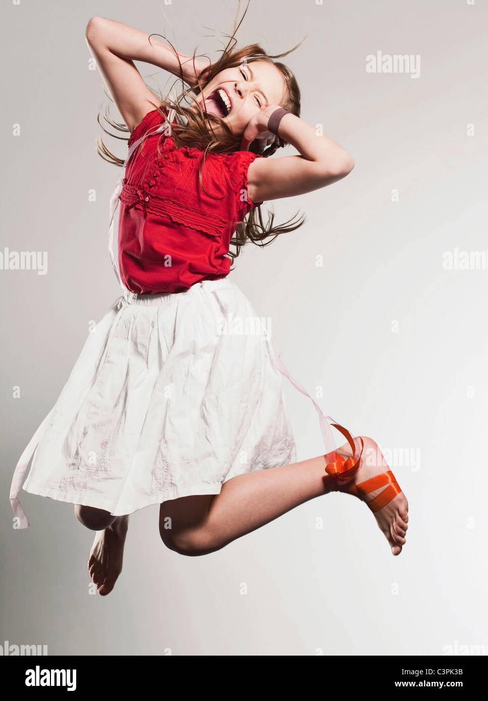 Girl (10-11) jumping and shouting Stock Photo - Alamy