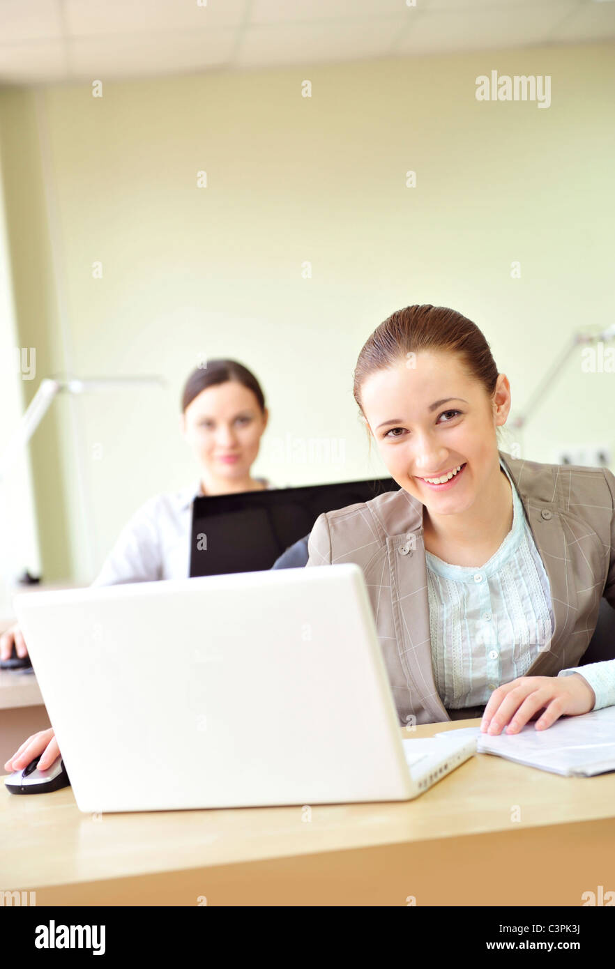 Portrait of relaxed and happy business woman in an office environment ...