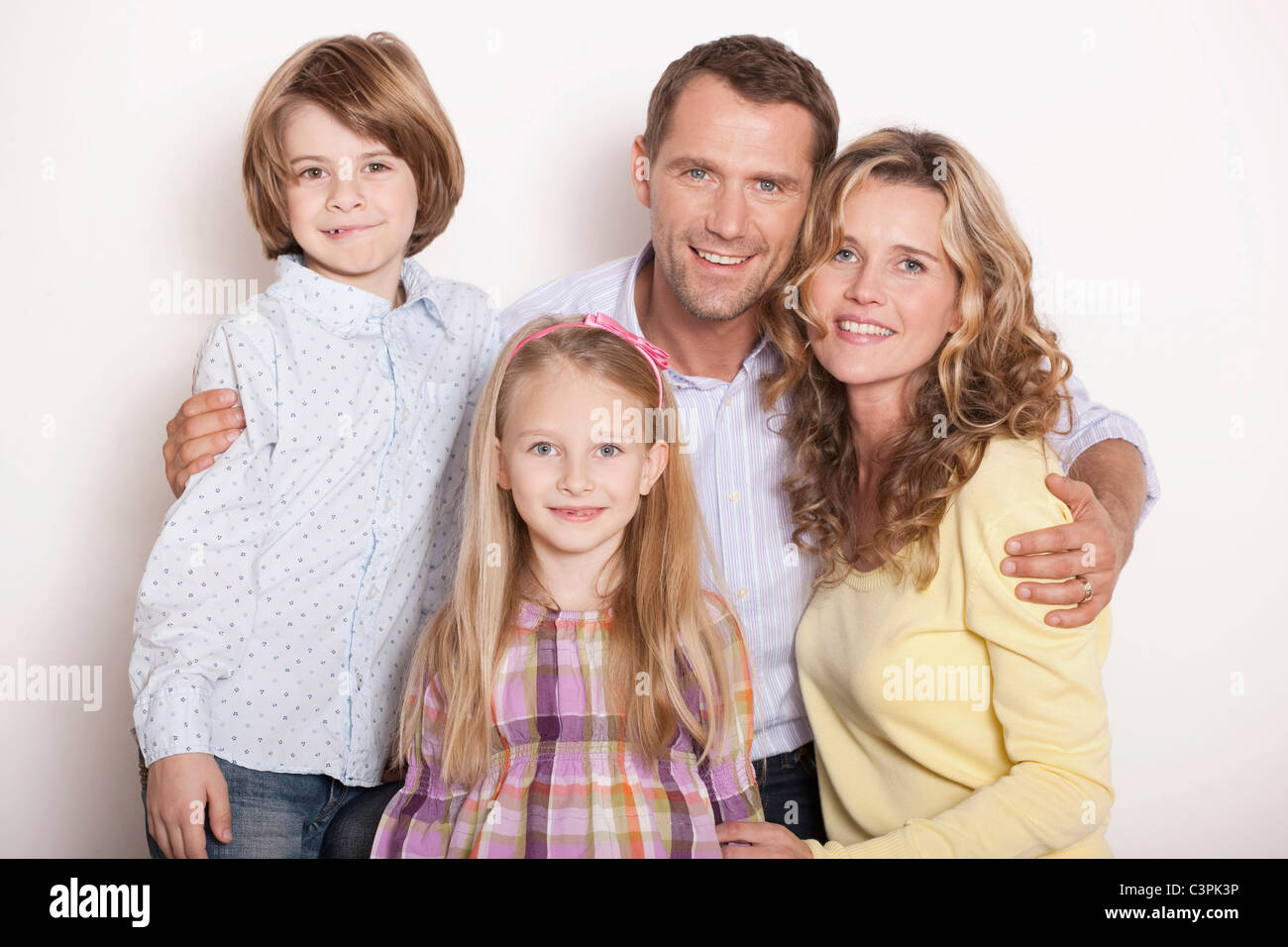 Germany, Cologne, Family embracing, smiling, portrait, close-up Stock ...