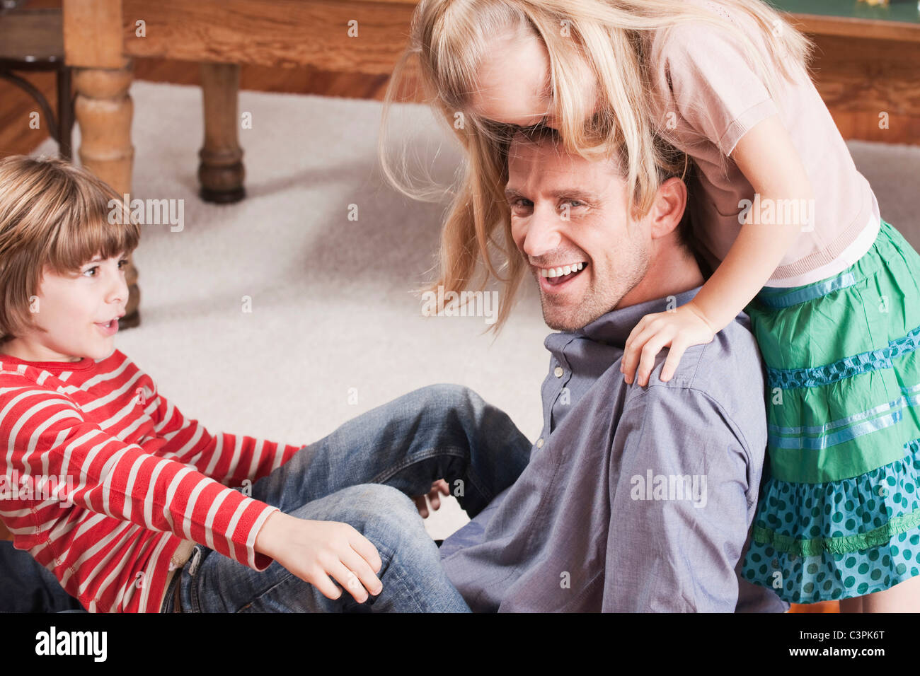Germany, Cologne, Father playing with his children (4-5), (6-7 ...