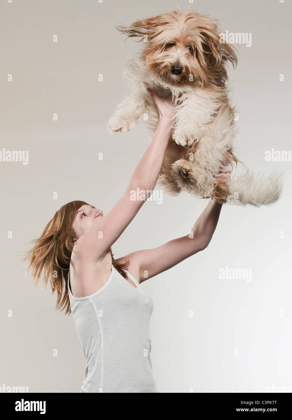 Teenage girl (16-17) lifting dog Stock Photo - Alamy