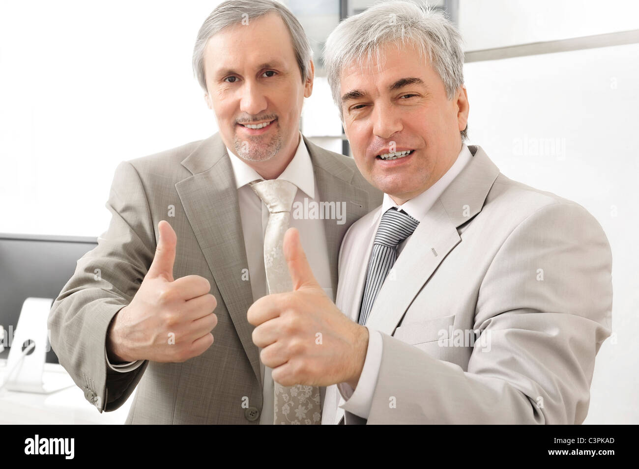 Portrait of two businessmen who approve. Office background Stock Photo ...