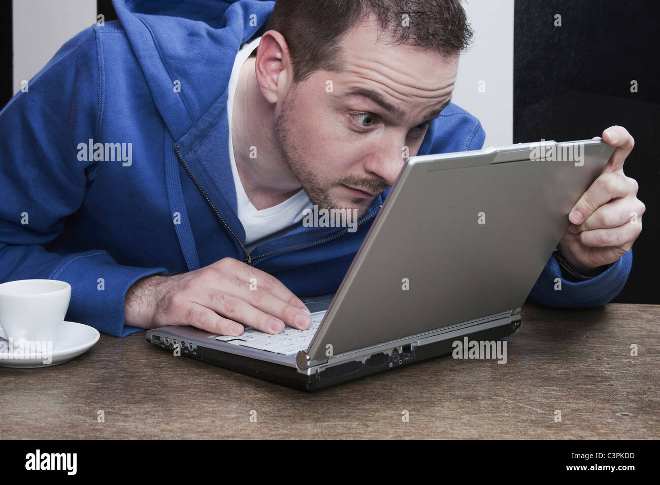 Man staring at laptop Stock Photo - Alamy